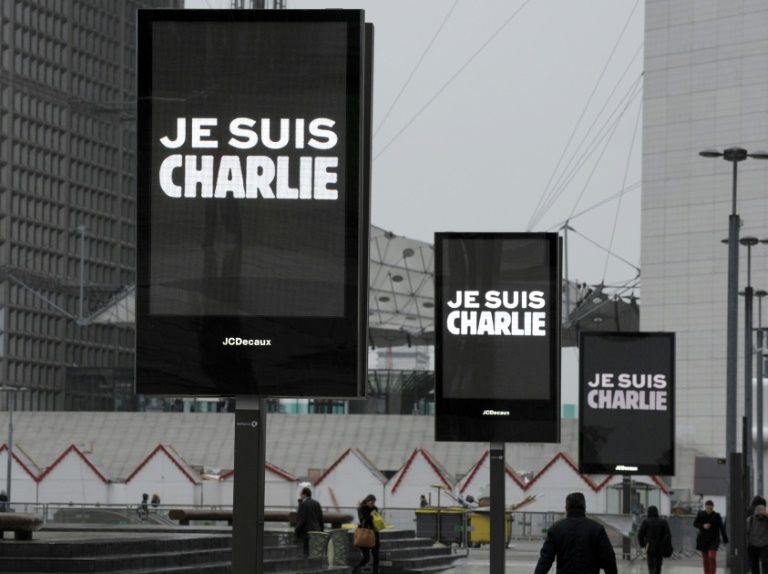 Charlie Hebdo Marks Anniversary Edition With Gun-wielding God - i24NEWS